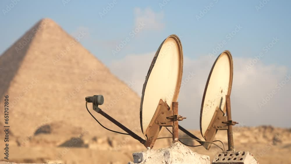 Satellite dishes against the background of The Great pyramid of Giza ...