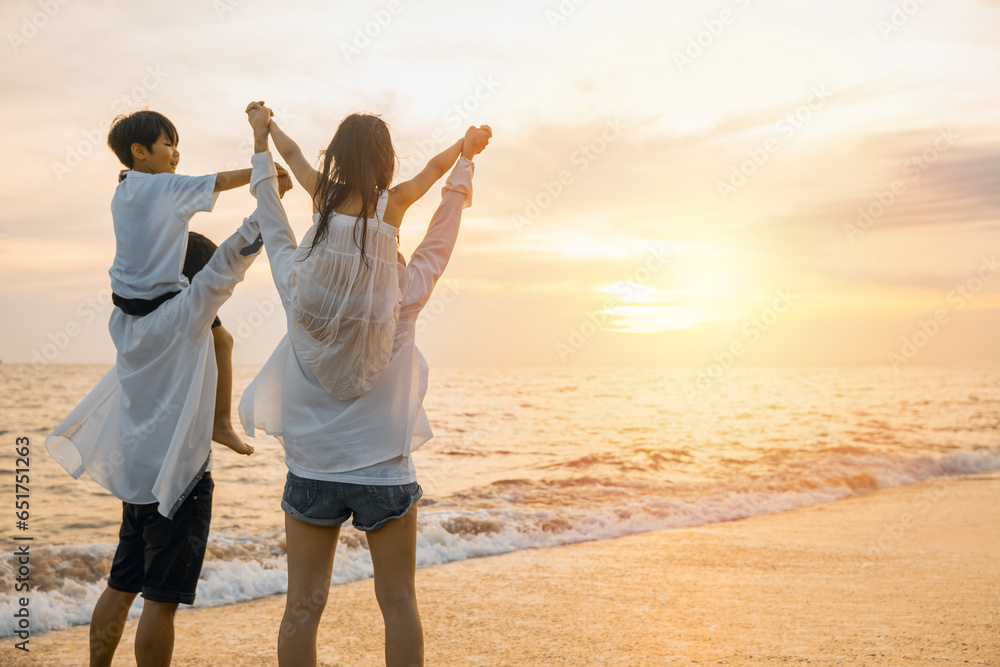 Father carrying son and Mother carrying daughter on shoulder walking ...