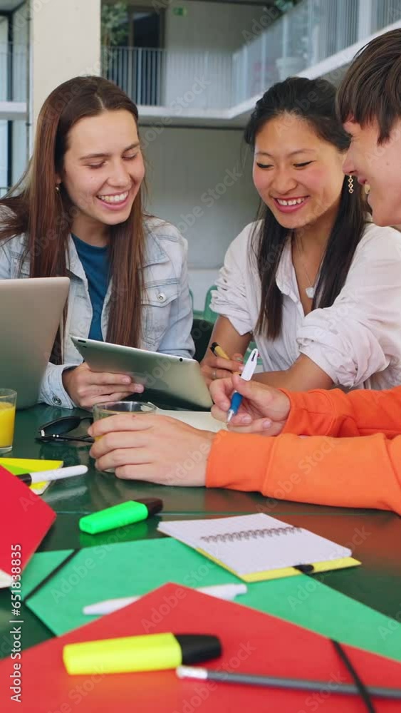 Secondary school students studying together with laptops at high school ...