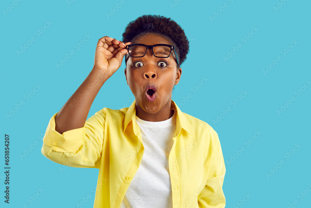 Surprised african american woman raising glasses looking shocked ...