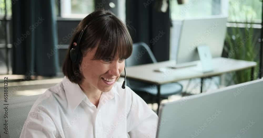 Friendly and approachable female call center agent conducts a phone ...