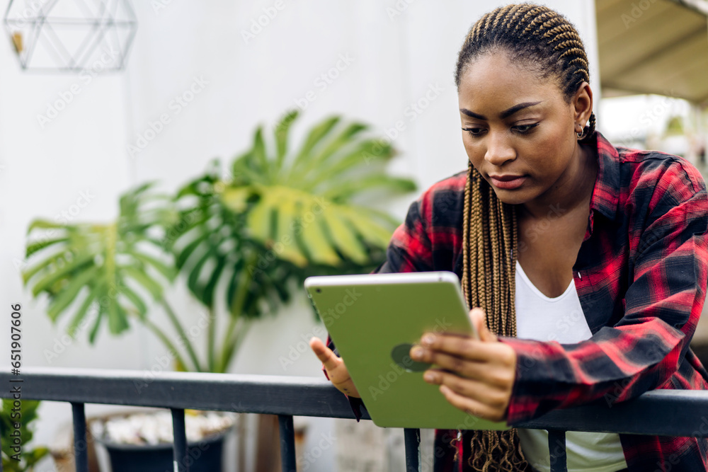 Portrait of of smiling happy african woman relaxing use technology of ...
