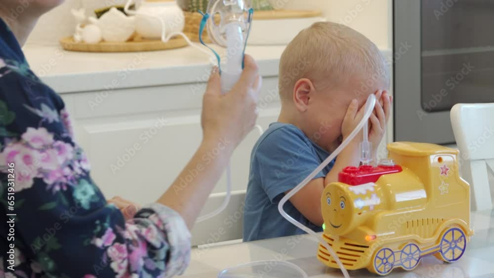 sick child crying while doing inhalation mother using nebulizer helps ...