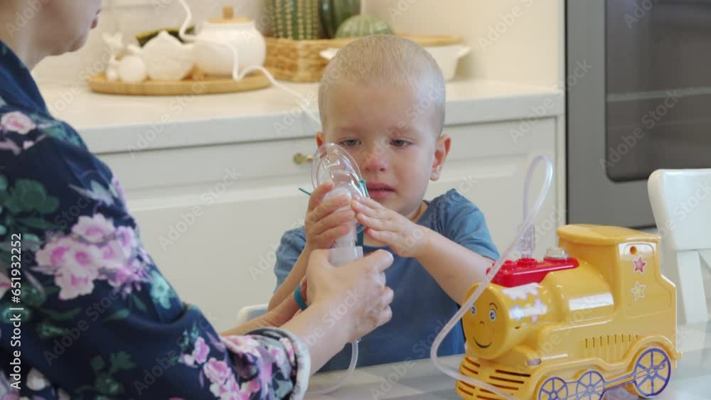 sick child crying while doing inhalation mother using nebulizer helps ...