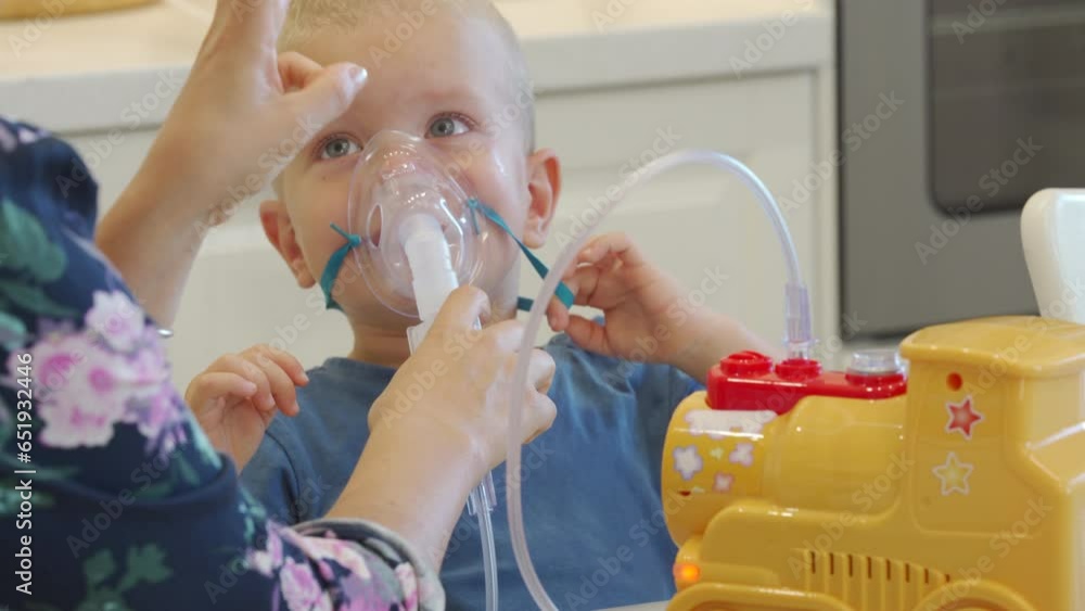 sick child crying while doing inhalation mother using nebulizer helps ...