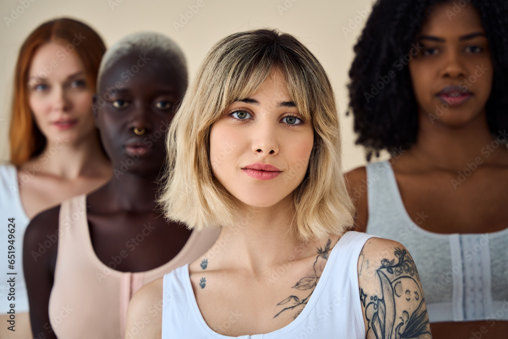 Happy cool pretty gen z blonde tattooed girl wearing top looking at ...