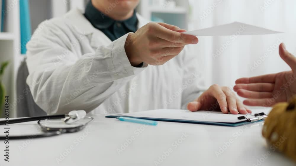 Specialist doctor in attire signing a paper document in a gynecologist ...