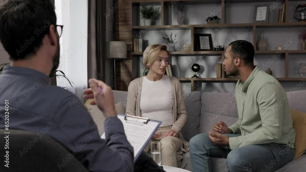 Multiracial quarrel between husband and wife at a session with a ...