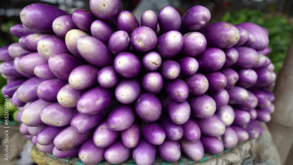 Fresh brinjal at market. Brinjal, also known as eggplant or aubergine ...