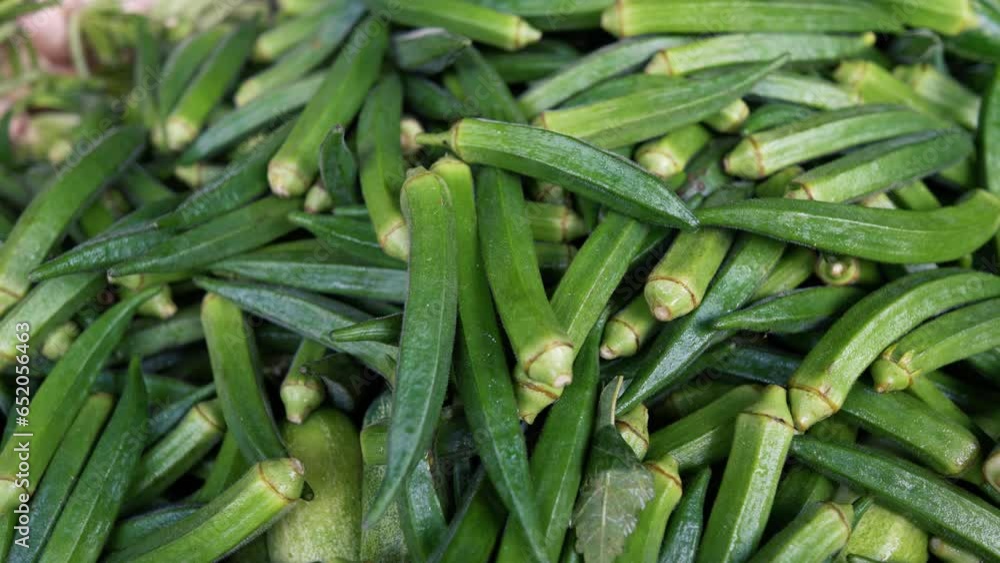 Fresh raw okra at market. Okra, also known as bhindi, lady's finger ...