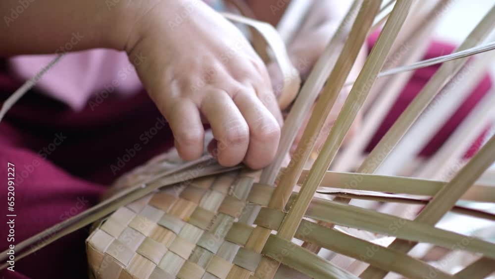 An Indonesian woman´s hand weaving an ancestral basket case from ...