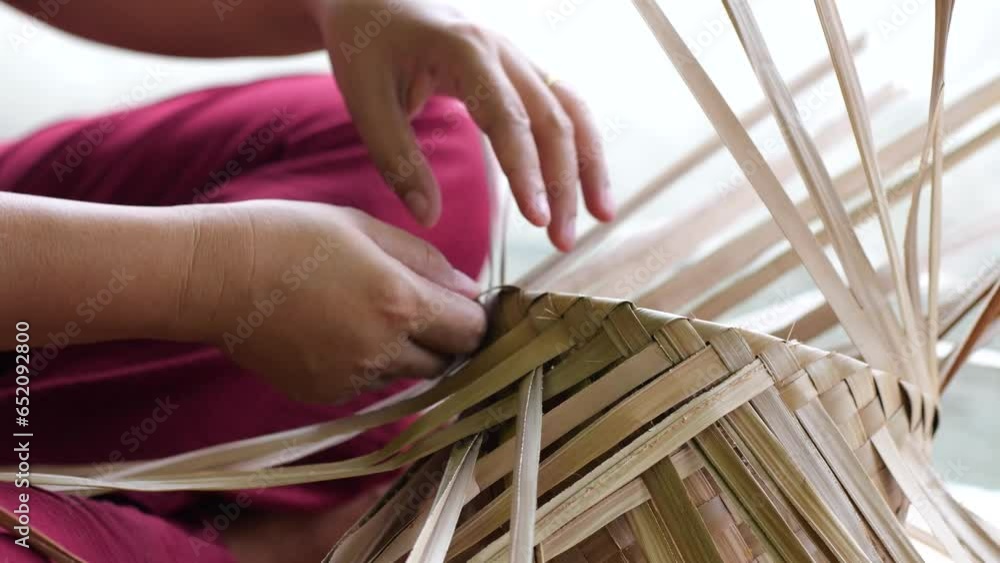 An Indonesian woman´s hand weaving an ancestral basket case from ...
