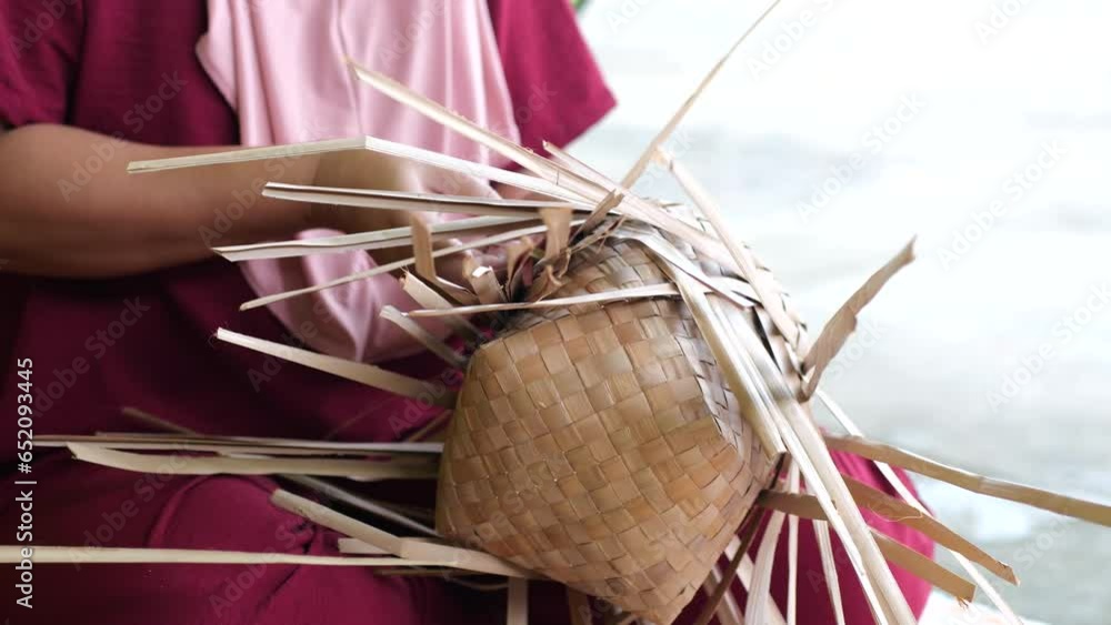 An Indonesian woman´s hand weaving an ancestral basket case from ...