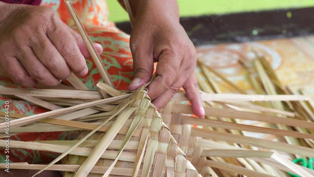An Indonesian woman´s hand weaving an ancestral basket case from ...