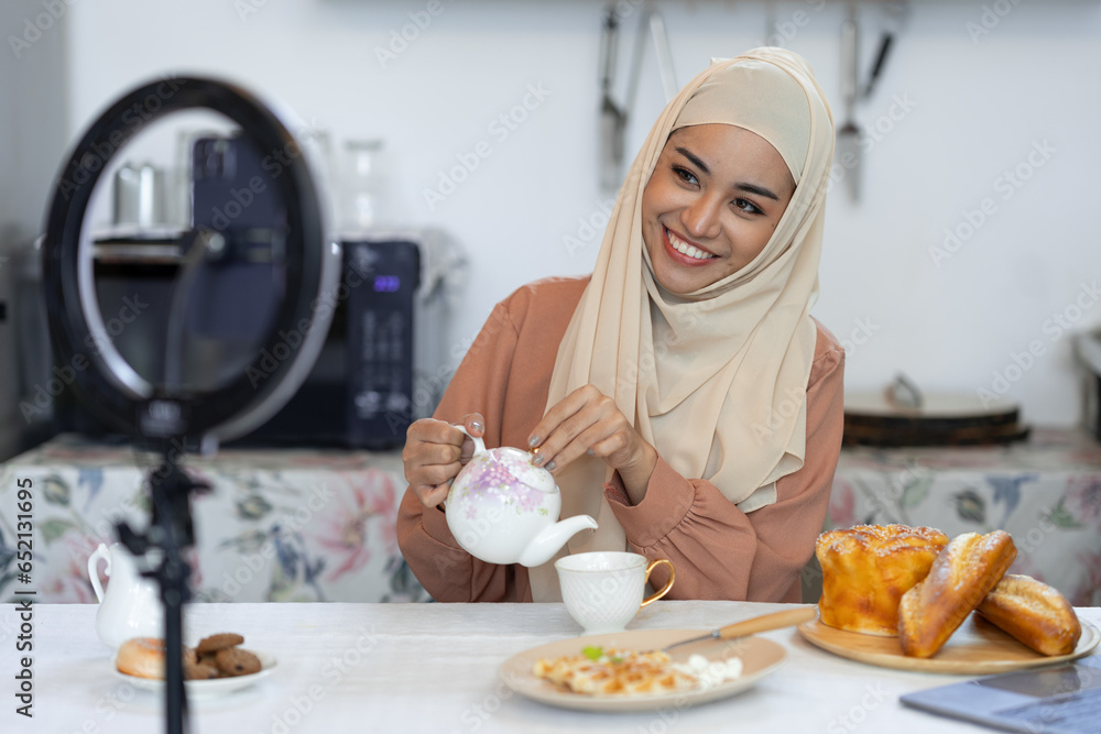 Young Muslim woman in hijab showing off a menu of desserts, bread ...