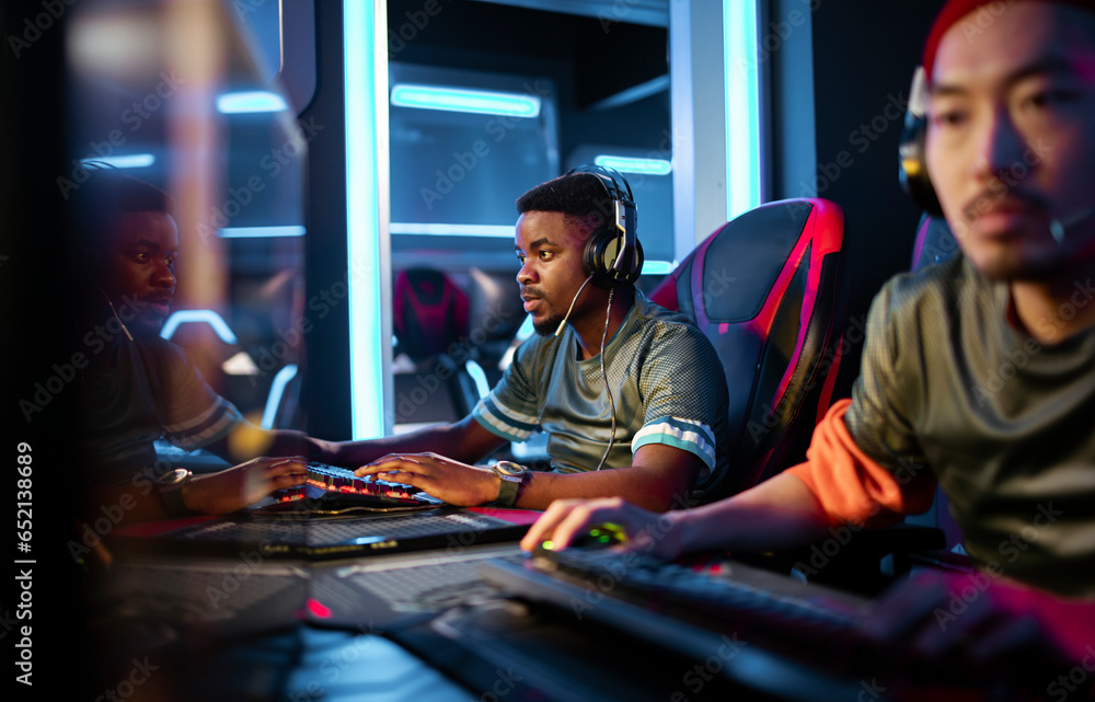 Diverse group of friends playing video games together and competing in ...