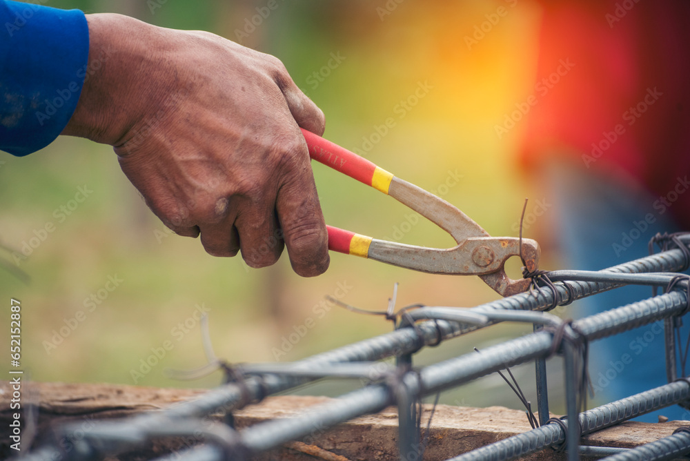 Construction Worker hands using pincer pliers iron wire. Outdoor Worker ...