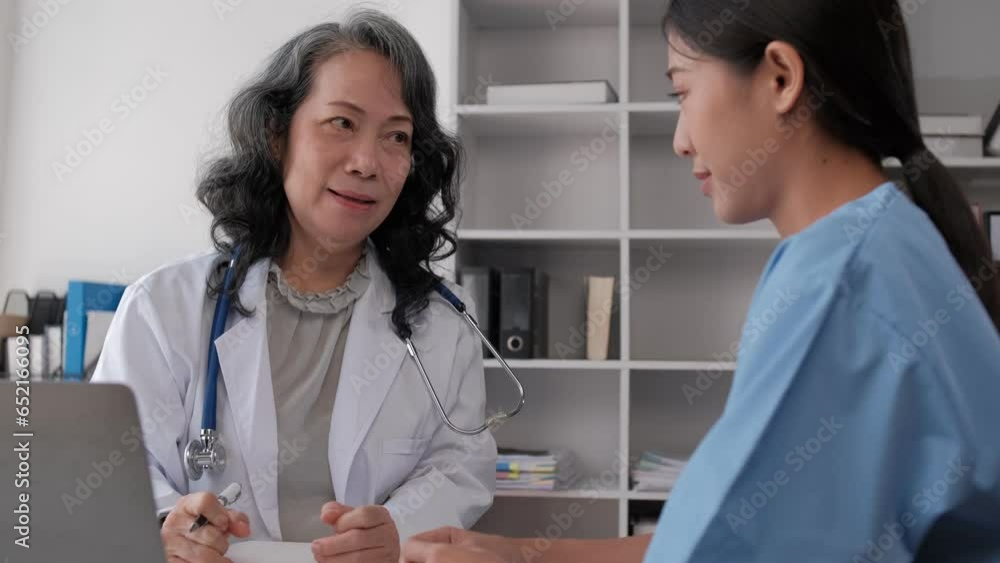 A senior female doctor is giving advice to medical students in the ...