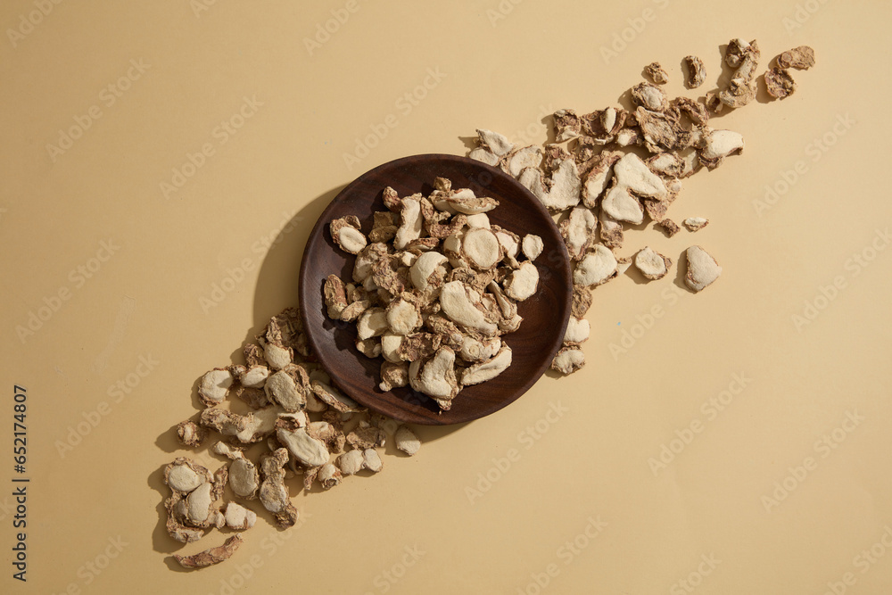 Sand Ginger displayed on a wooden dish against the beige background ...