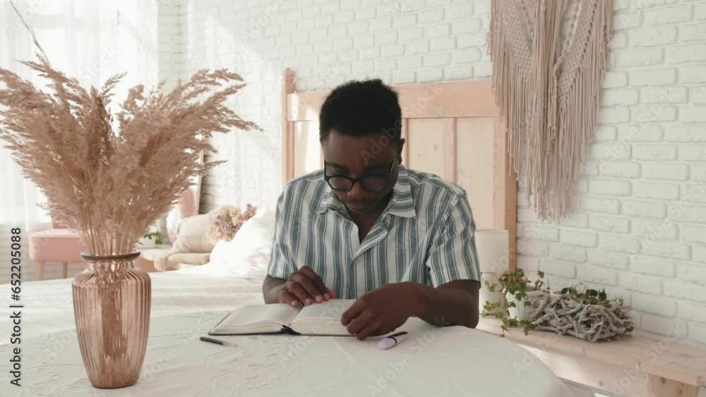 African black man reading bible. Fingers going line by line of the text ...