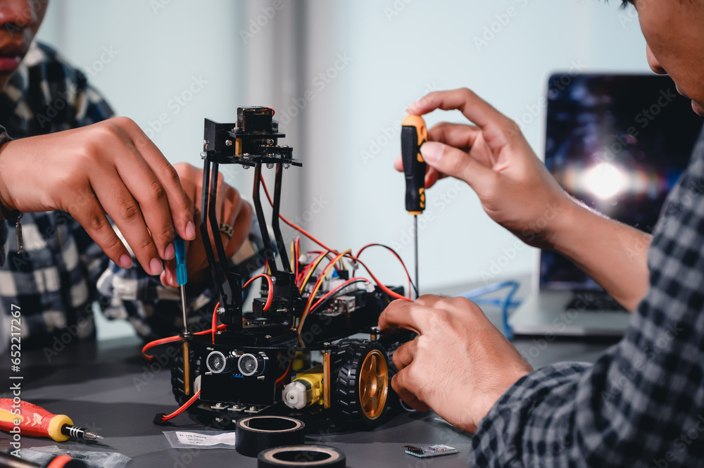 Engineer Asian Students Assembling Robotics Kits. Learning Mechanical ...
