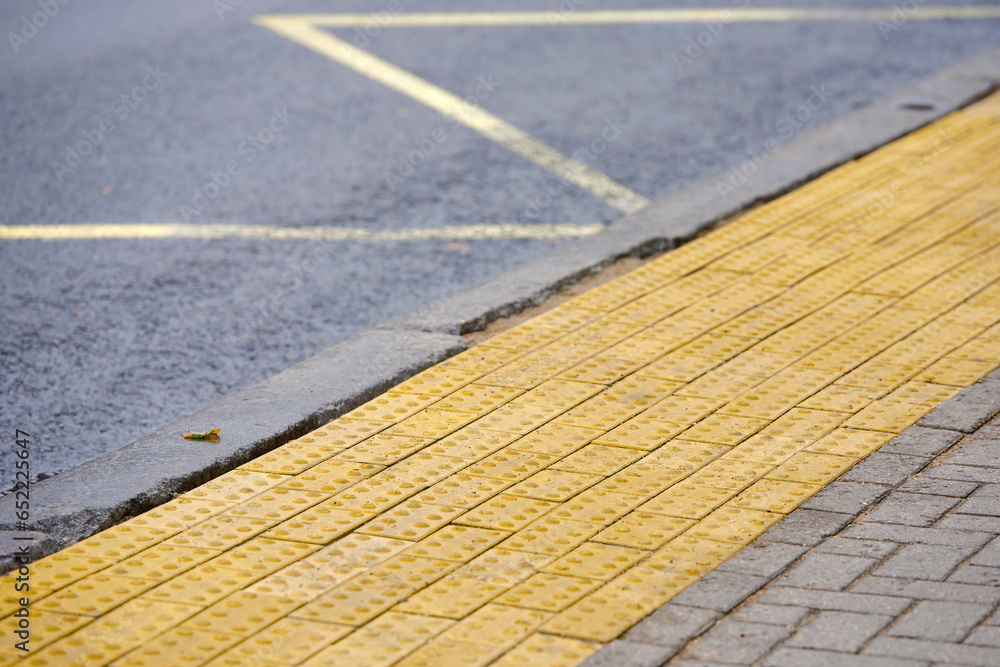 Yellow blocks for blind handicap on tiles pathway, walkway for ...