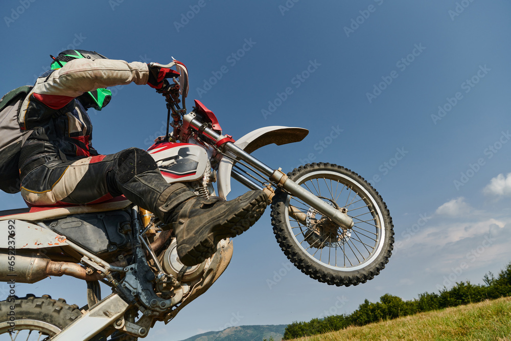 A fearless professional motocross rider skillfully executes an extreme ...