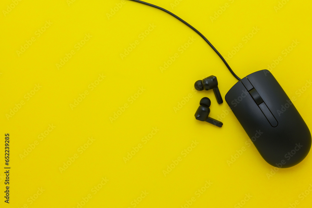 Simple black computer mouse with cord and wireless earbuds isolated on ...