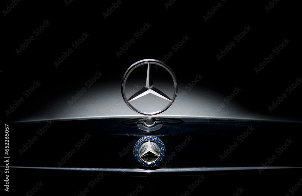 Mercedes Star logo on a vintage car with studio lighting and a black ...