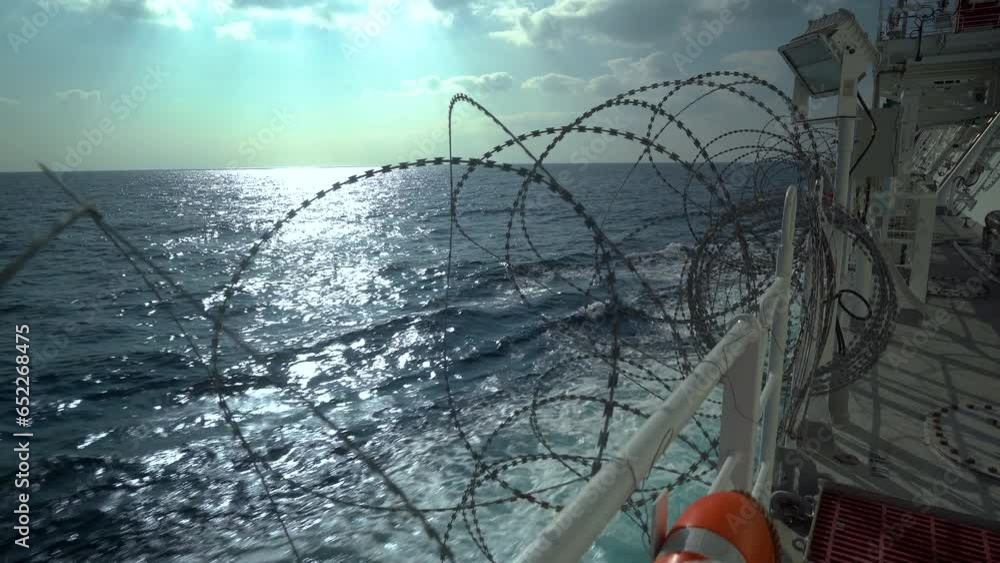 Barbed wire on ship railings. Protection from pirates. Open deck in ...