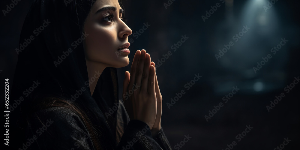 Side view of a woman praying at night, night mood with copy space Stock ...