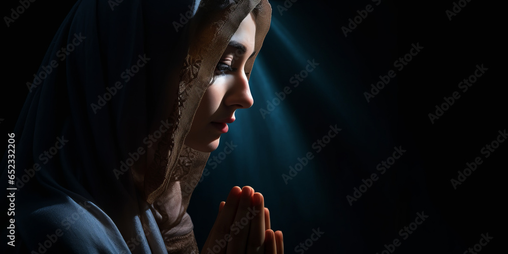Side view of a woman praying at night, night mood with copy space Stock ...