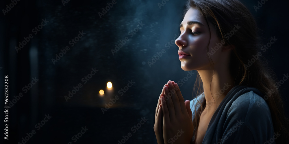 Side view of a woman praying at night, night mood with copy space Stock ...
