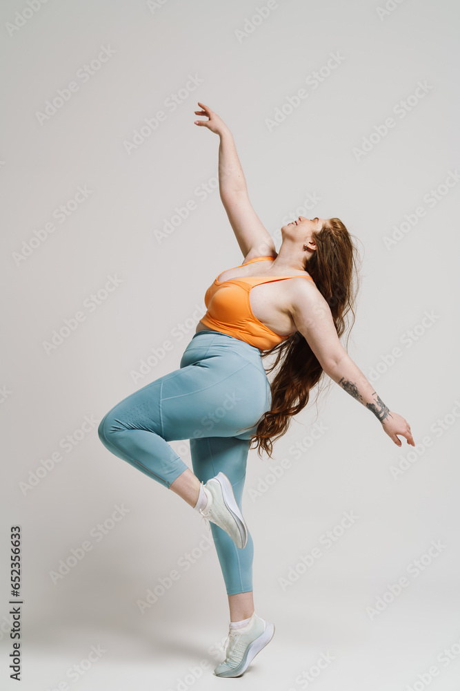 Beautiful plus size woman dancing isolated over white background Stock ...