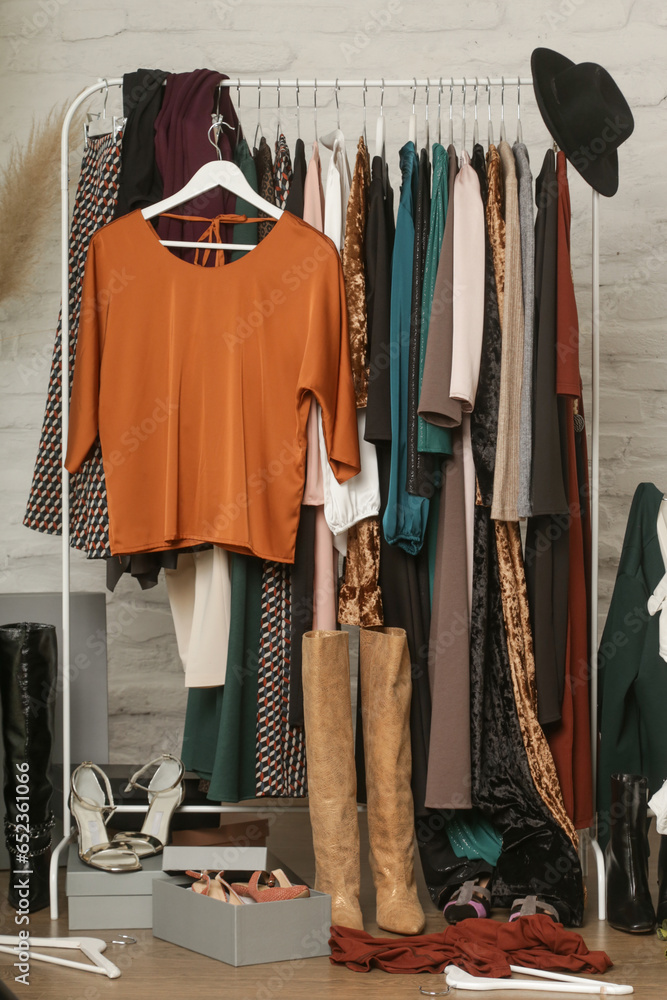Untidy cluttered woman wardrobe with stylish clothes and accessories ...