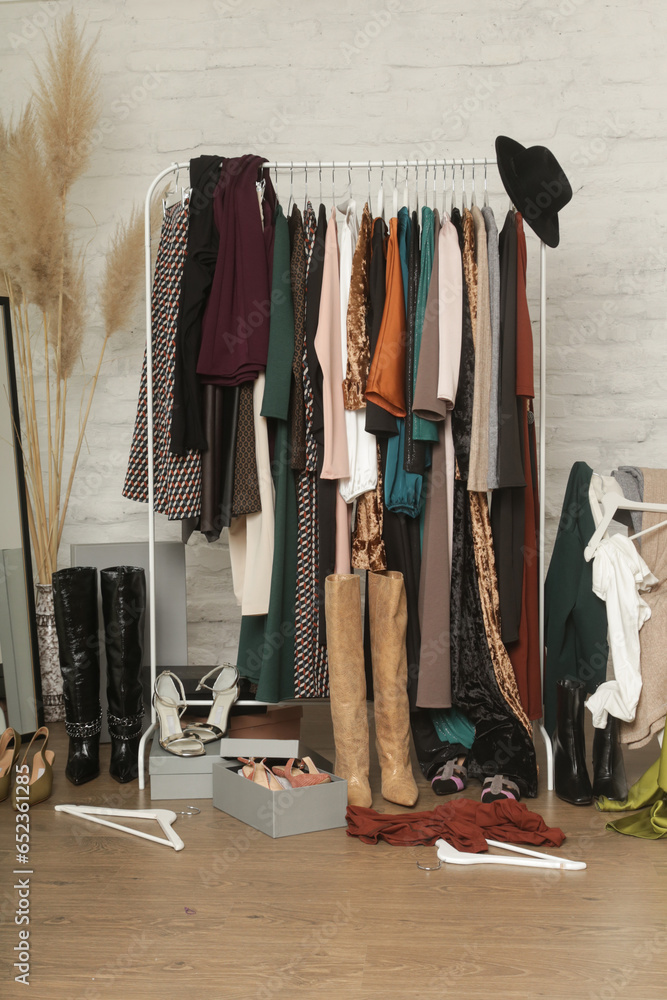 Untidy cluttered woman wardrobe with stylish clothes and accessories ...