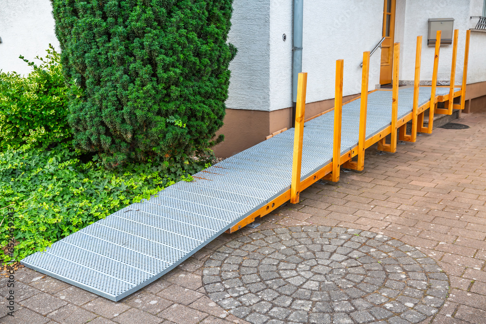 Wheelchair ramp fitted to front of family house, barrier-free zone ...
