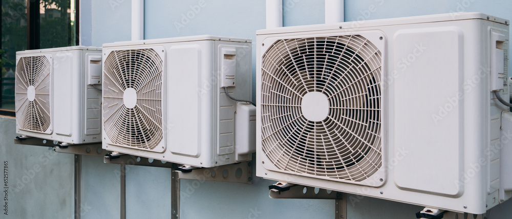 Air conditioner compressor installed on the roof of a building, along ...