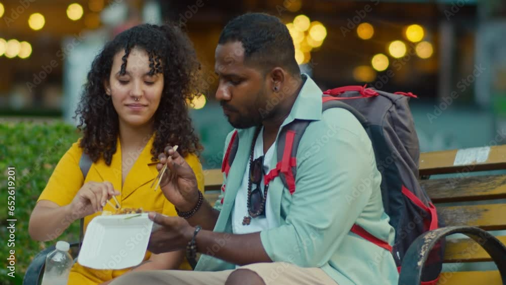 Medium close-up shot of Indian man and biracial girl enjoying delicious ...