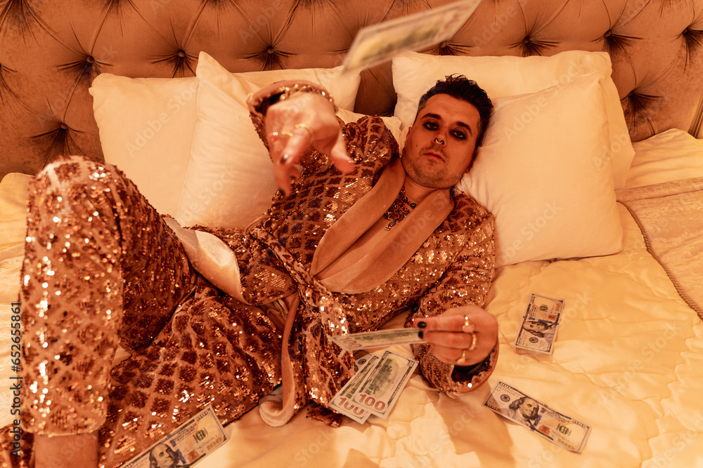 Rich and eccentric man dressed in a shimmering golden suit with a lot ...
