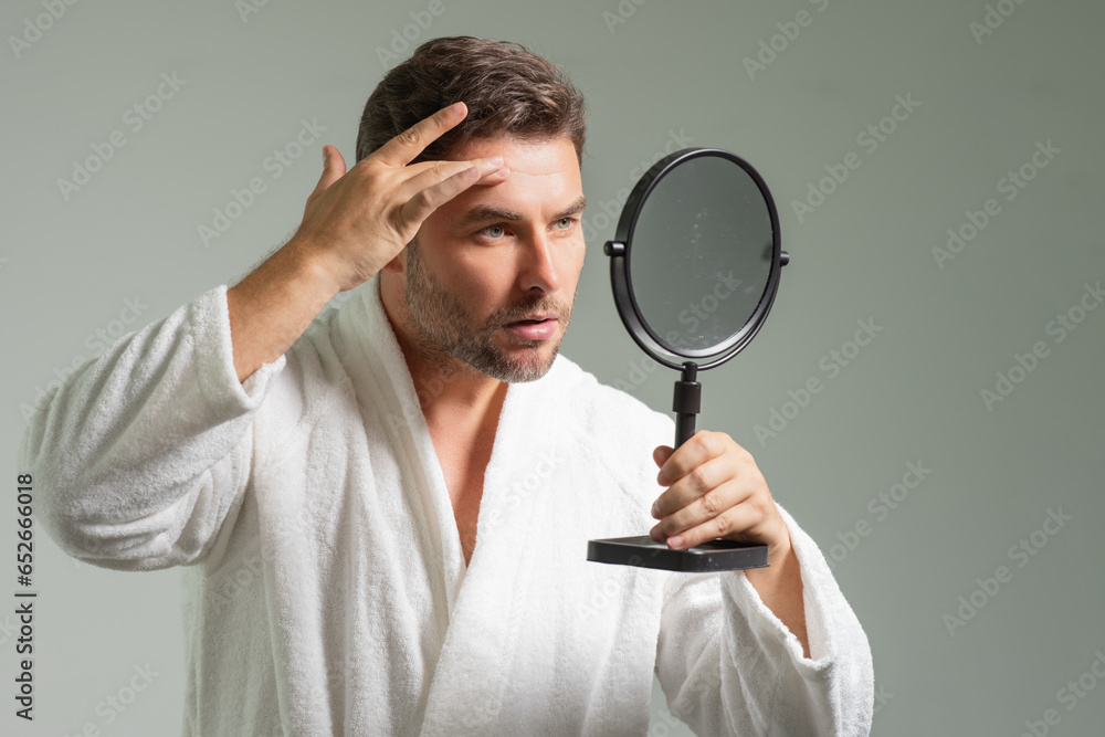 Close-up portrait of perfect brunet man touching chin and skin. Handsome man touching face in ...