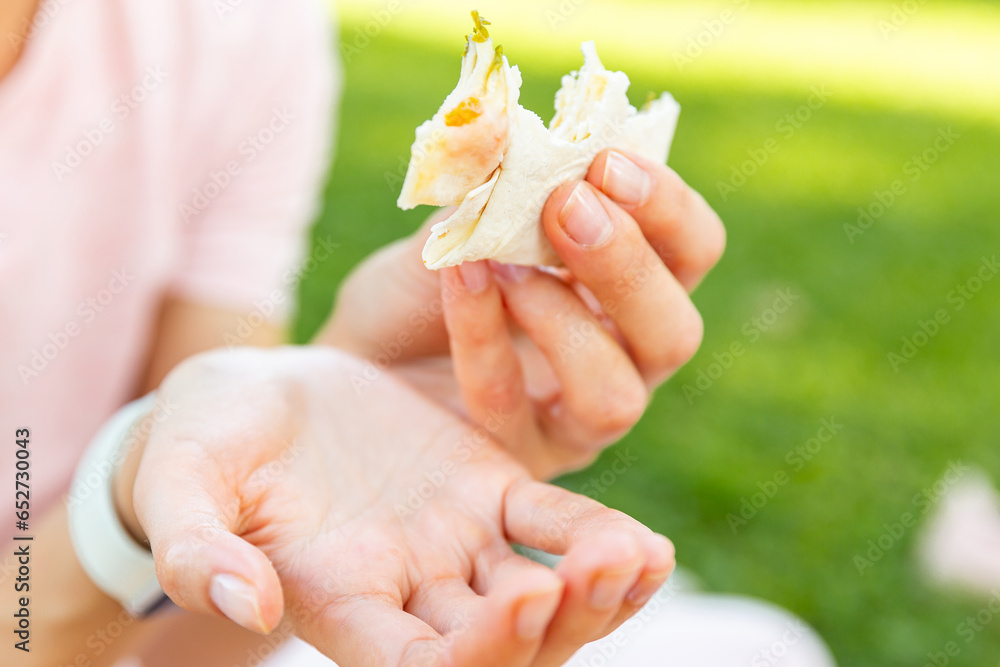 Close up of hands handling food outdoor. Woman hand holding deletions ...