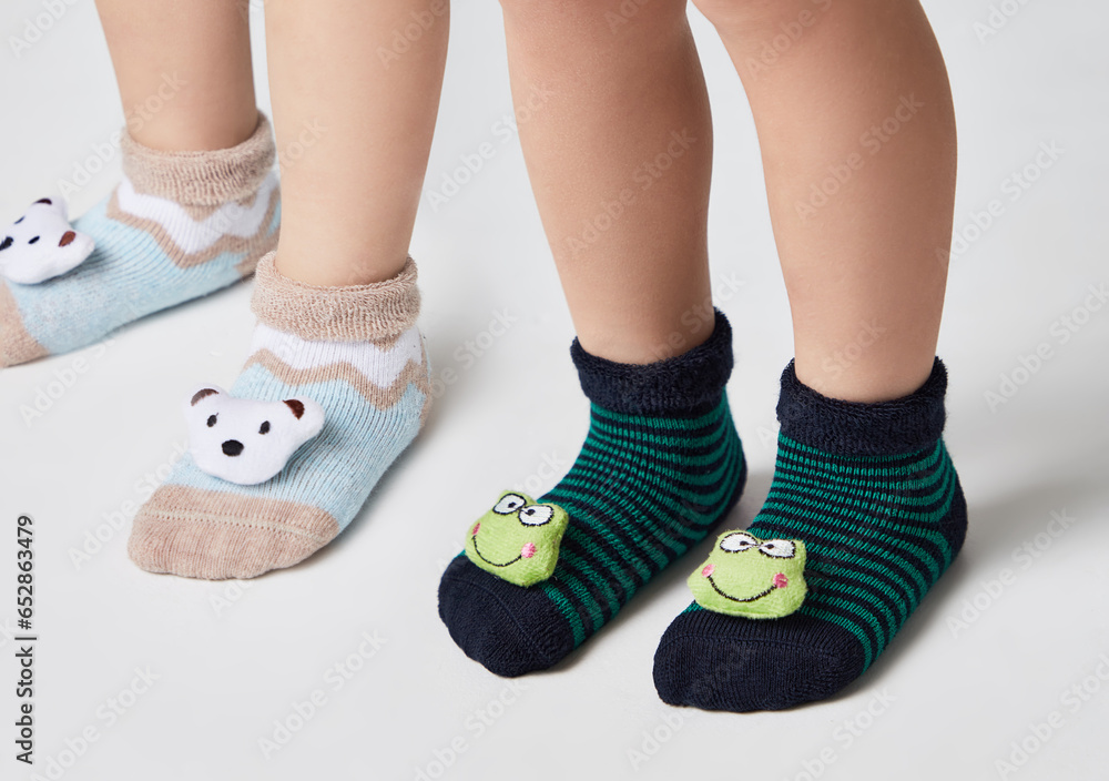 Children wearing pair of socks. Top view to kids foots in mismatched ...