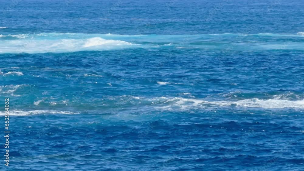 Ocean waves forming lines and vertically separating the thirds of the ...