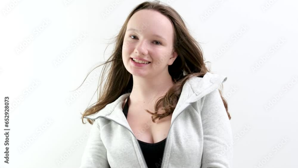 young beautiful teenage girl on a white background in a blissful ...