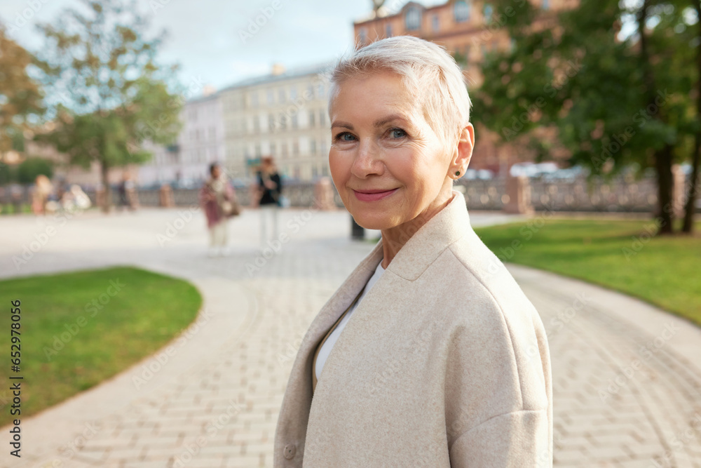 Happy elegant woman tourist of 60s admiring beautiful picturesque ...