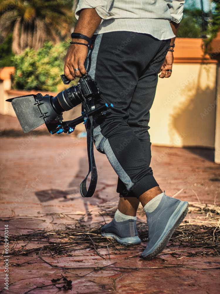 Filmmaker touring the city with his camera taking images for his film ...