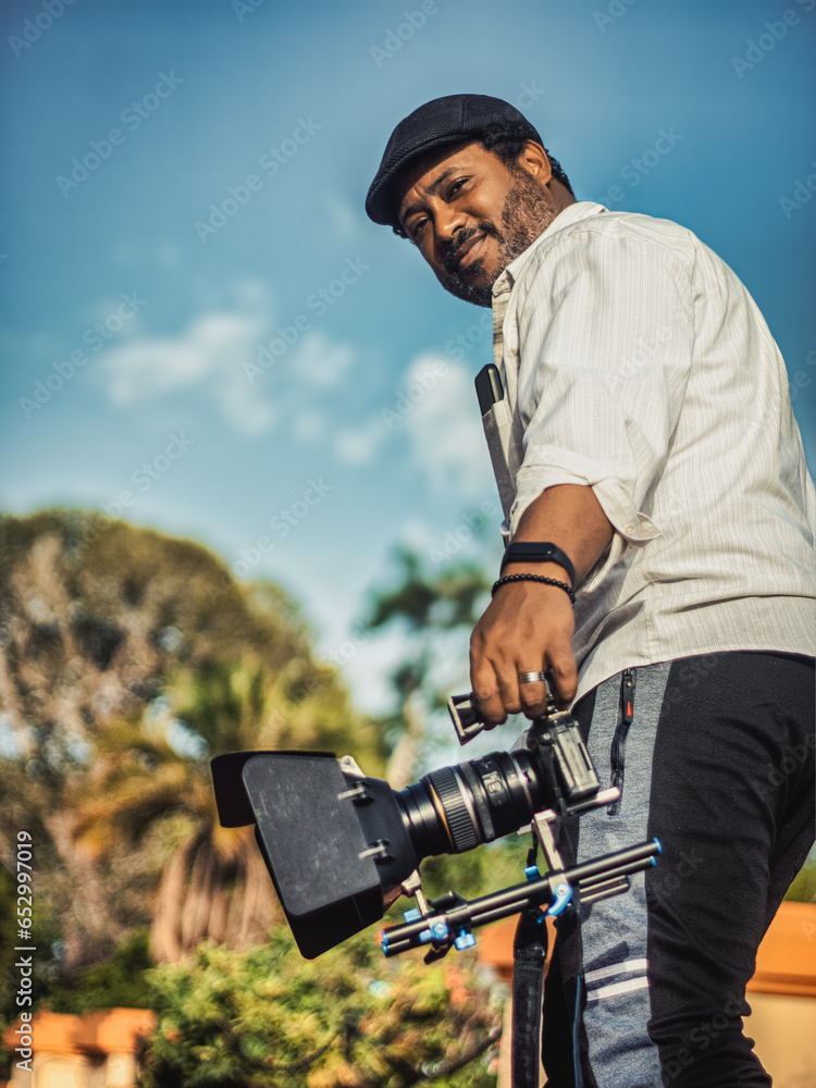 Filmmaker touring the city with his camera taking images for his film ...