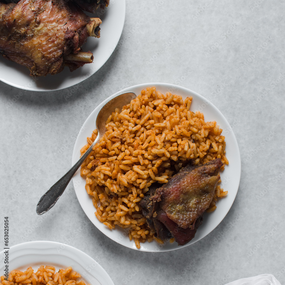 Jollof rice and fried chicken on a white plate, homemade nigerian ...