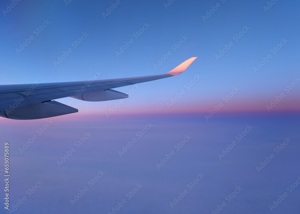 An airplane wing seen through an oval window. View on a North Pole ...